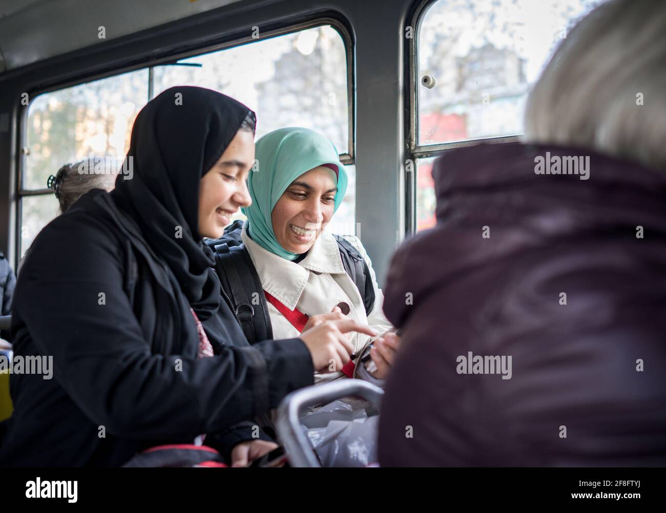 Mother and daughter riding public transport in the city Stock Photo - Alamy