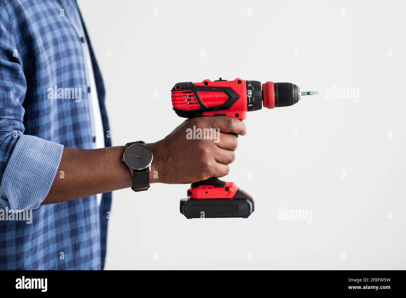 Home renovation, electric tool. Black man with smart watch holding ...