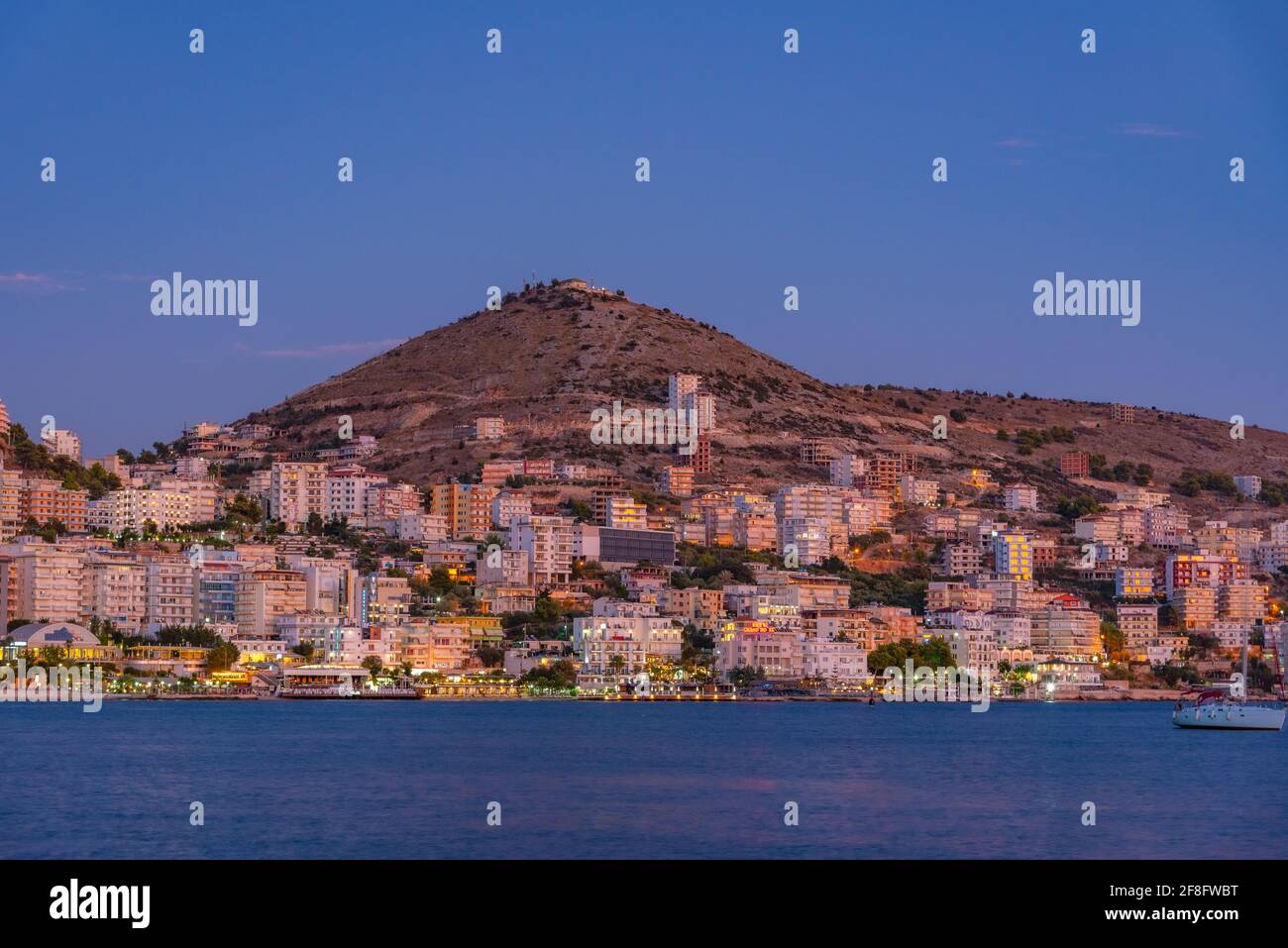 Sunset view of seaside of Sarande with Lekuresi castle, Albania Stock ...