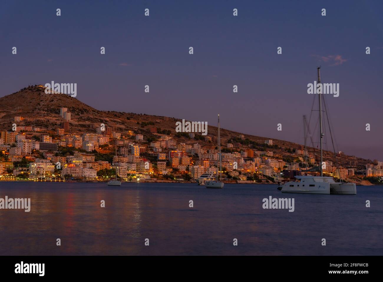 Sunset view of seaside of Sarande with Lekuresi castle, Albania Stock ...