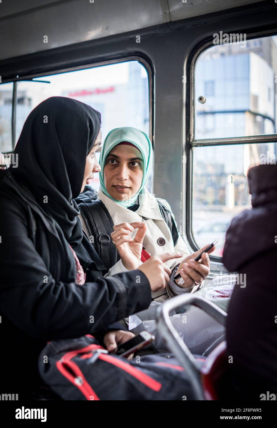 Mother and daughter riding public transport in the city Stock Photo - Alamy
