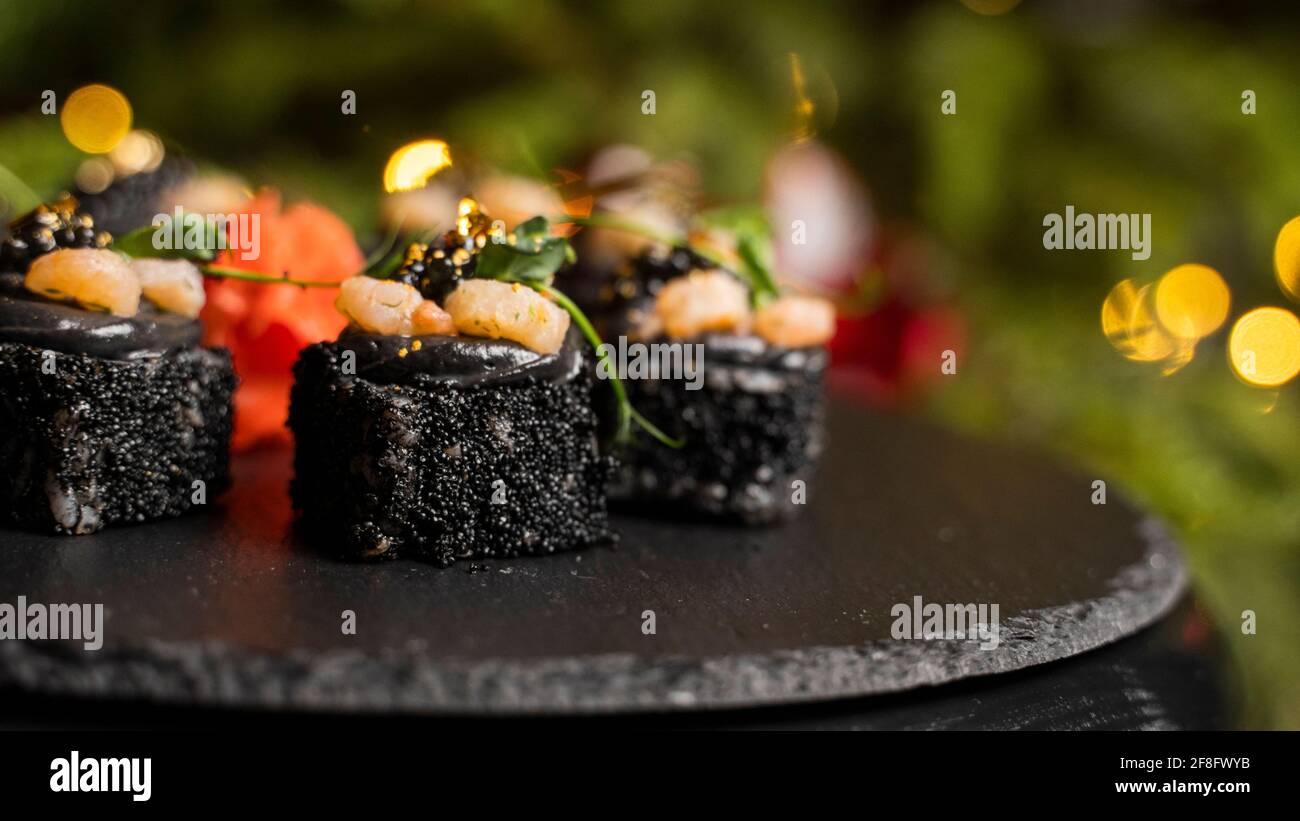 Sushi with black rice, crab meat, avocado, smoked salmon mousse, oar ...