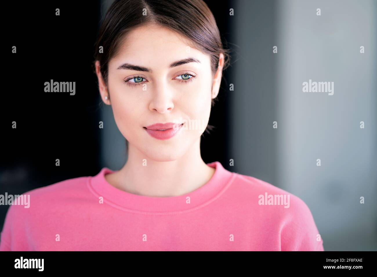 Close-up portrait of beautiful woman with brown hair and green eyes ...