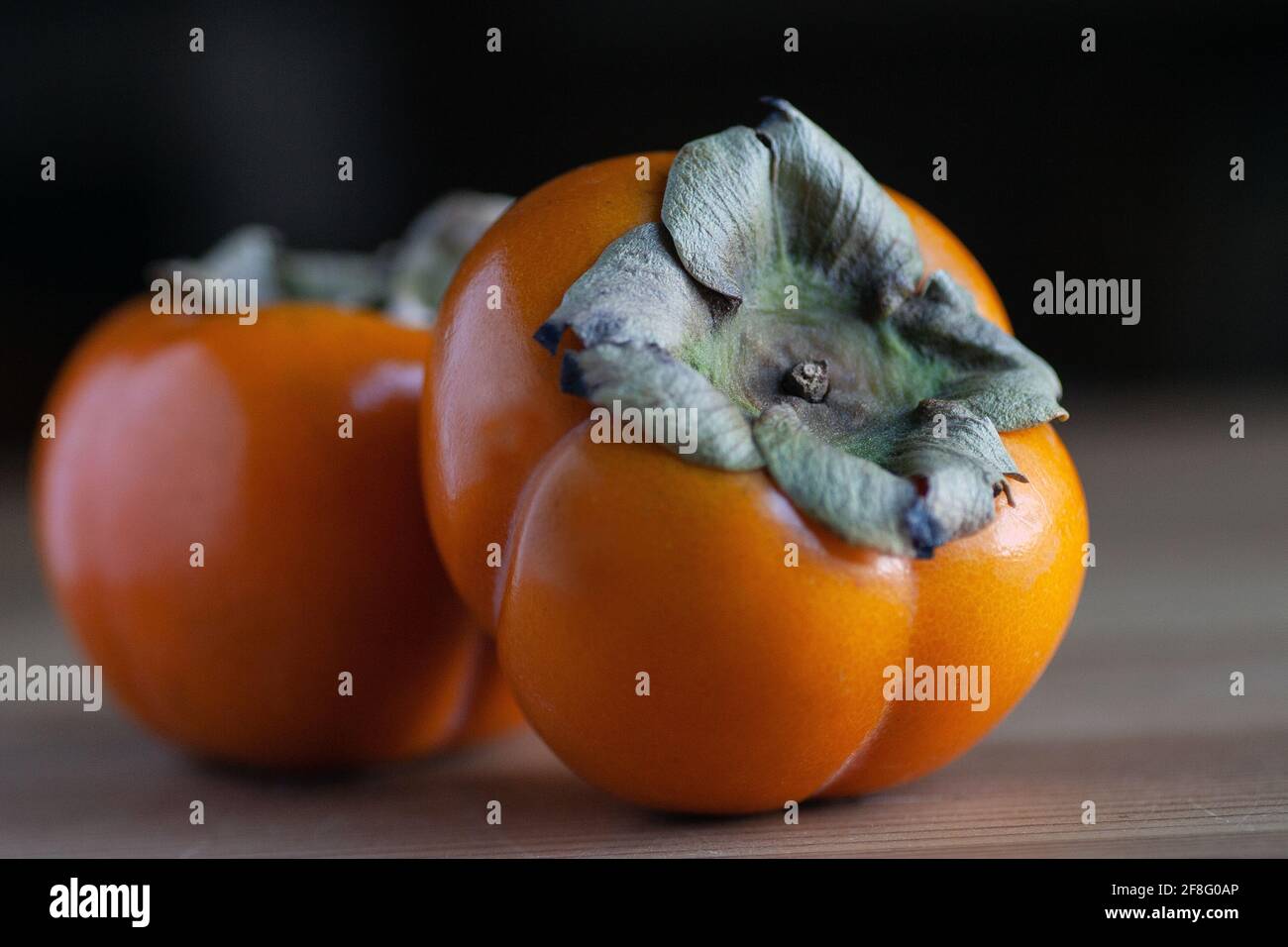 Two Persimmons or Sharon Fruit Stock Photo - Alamy
