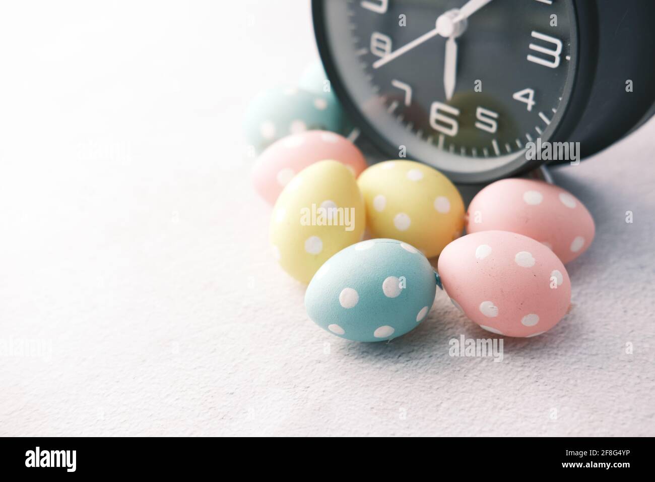 easter concept with egg and alarm clock on white background Stock Photo ...