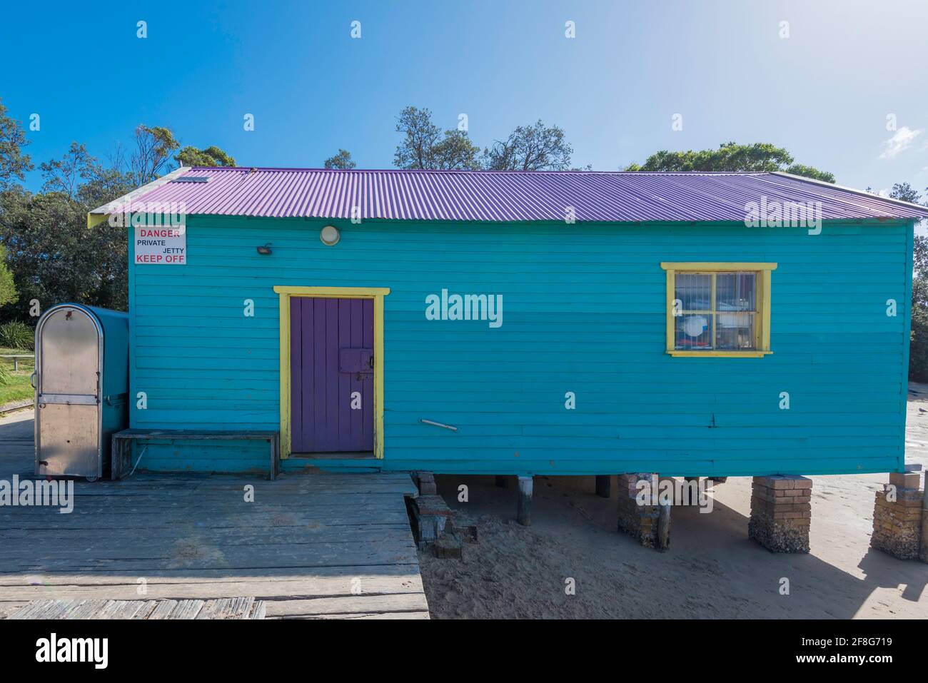 The multicoloured premises of Mitchies Boatshed at the mouth of Boggy ...