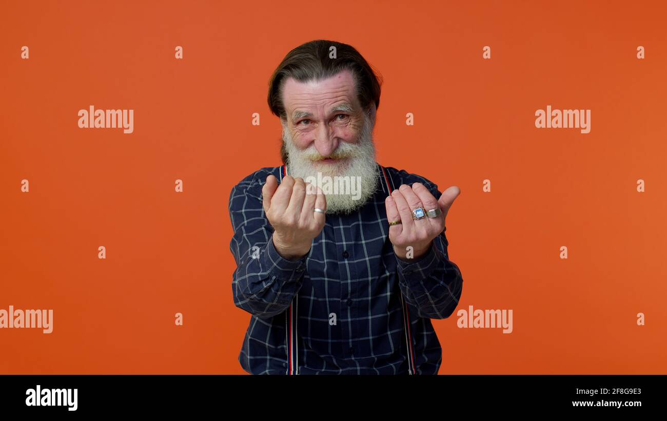 Senior old man pointing to camera with playful happy expression, making ...