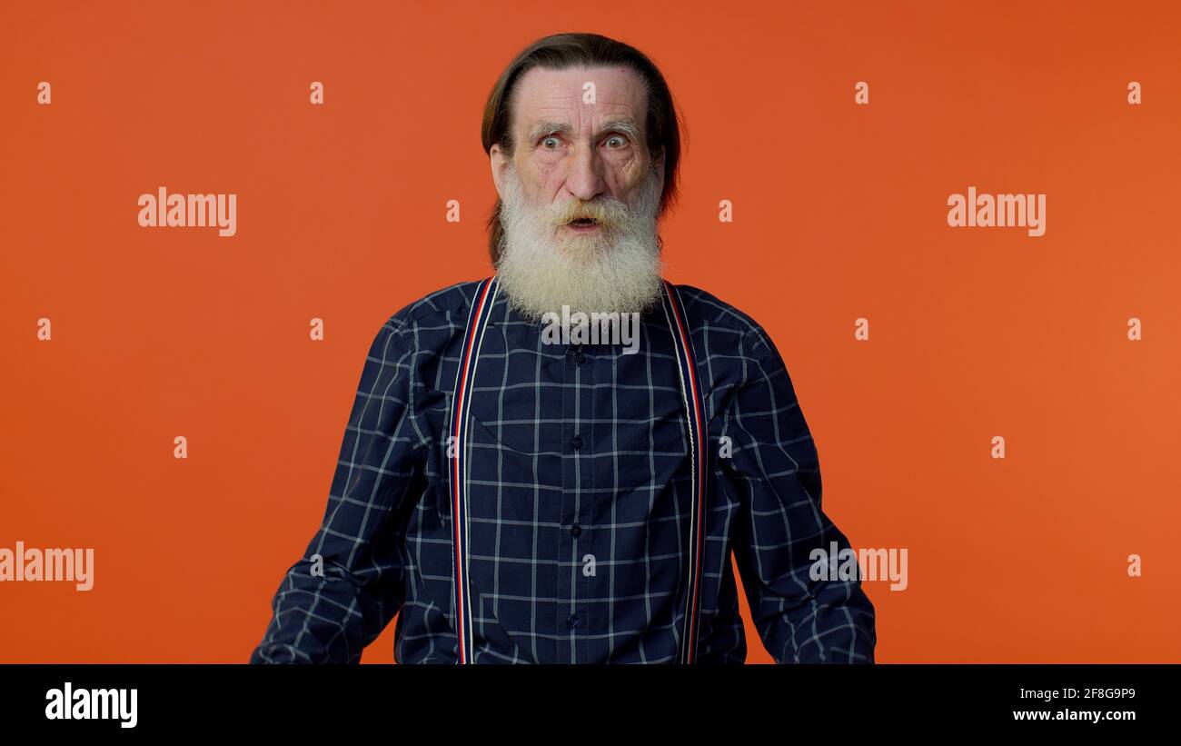 Stressed depressed mature old man expresses his fear and waves his ...