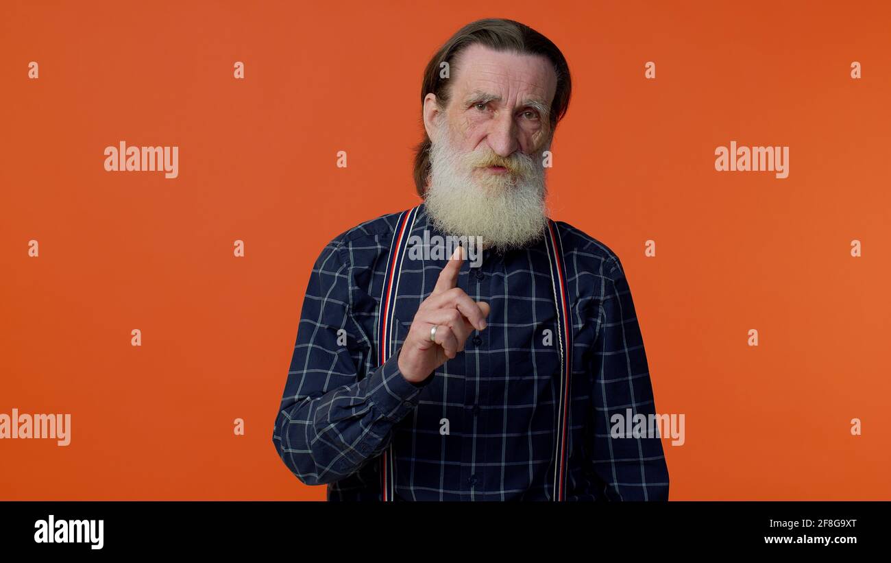 Elderly old man in warning with finger gesture, saying no, be careful ...