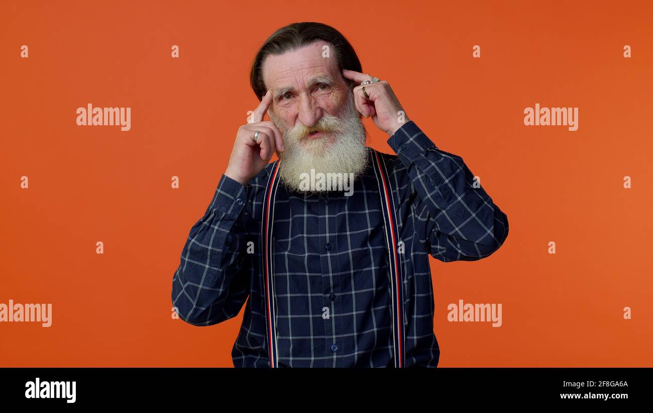 Senior old man pointing at camera and showing stupid gesture, blaming ...