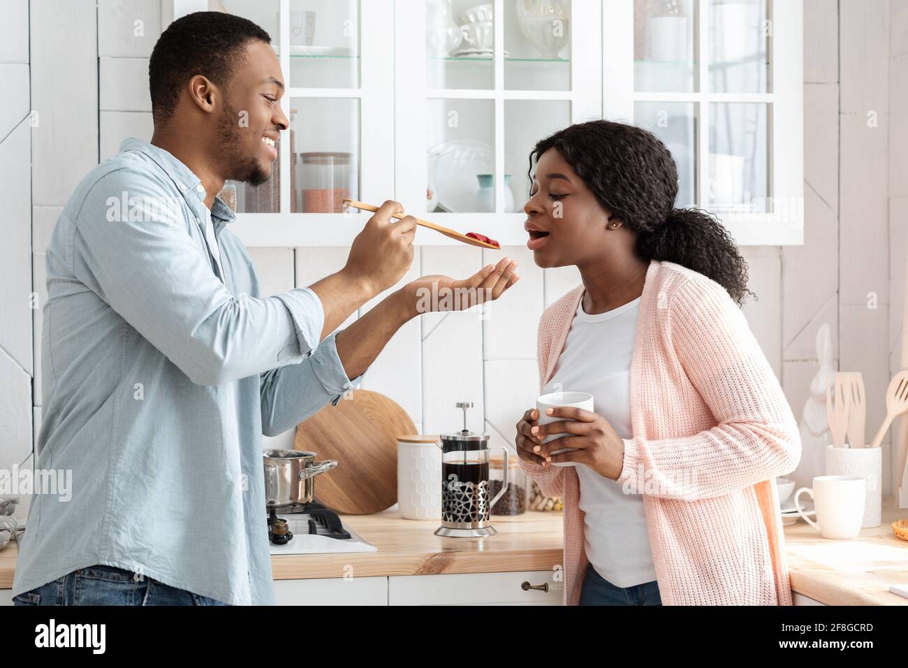 Romantic african american couple cooking healthy food together in ...