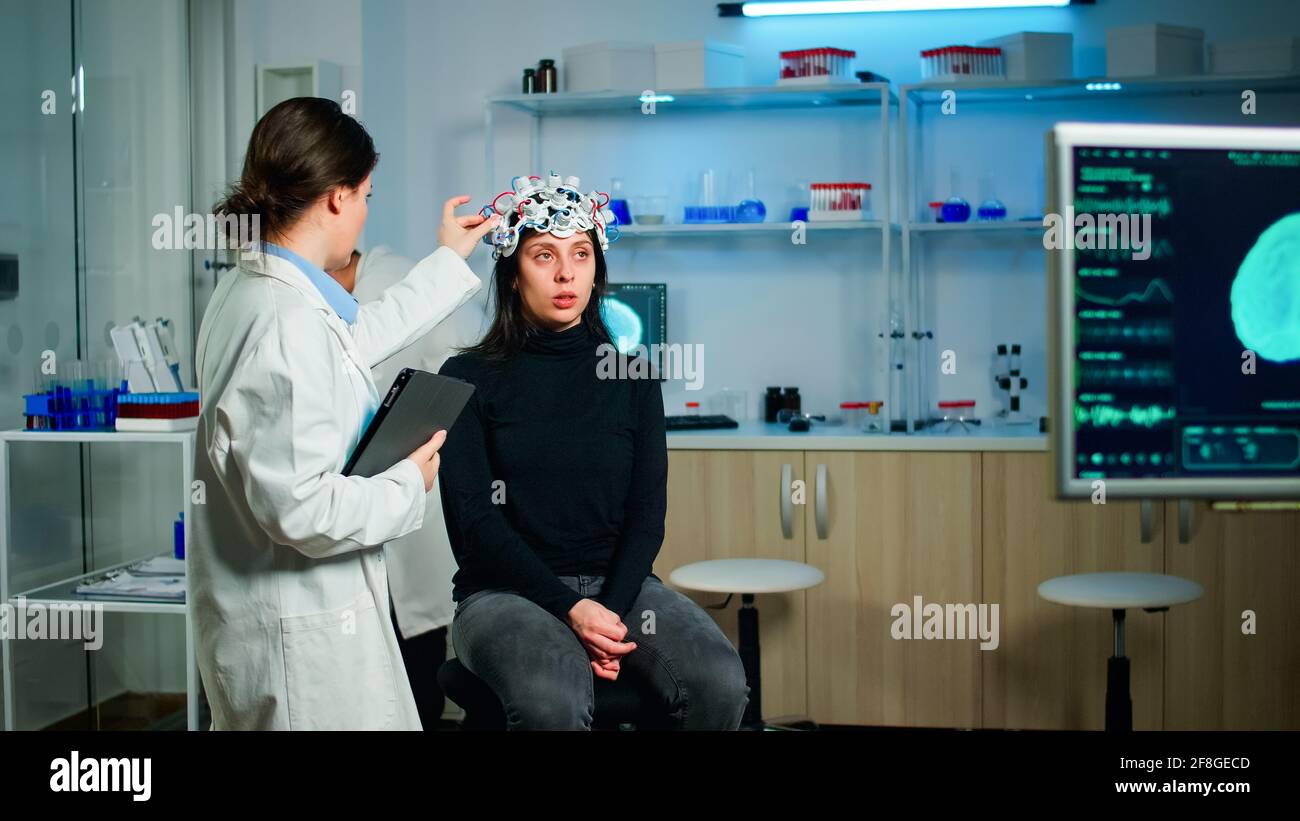 Doctor analysing brain scan using tablet, examining evolution of ...