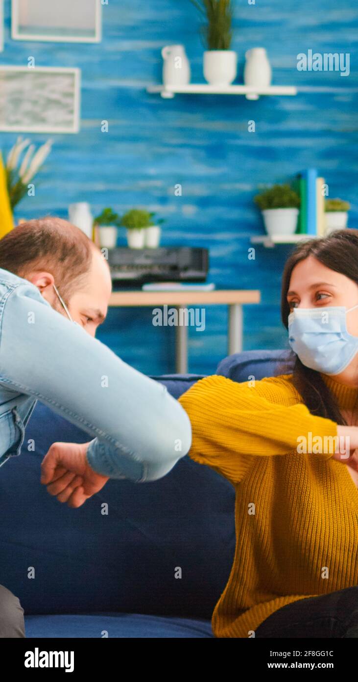 Cheerful friends touching elbow keeping hi-res stock photography and ...