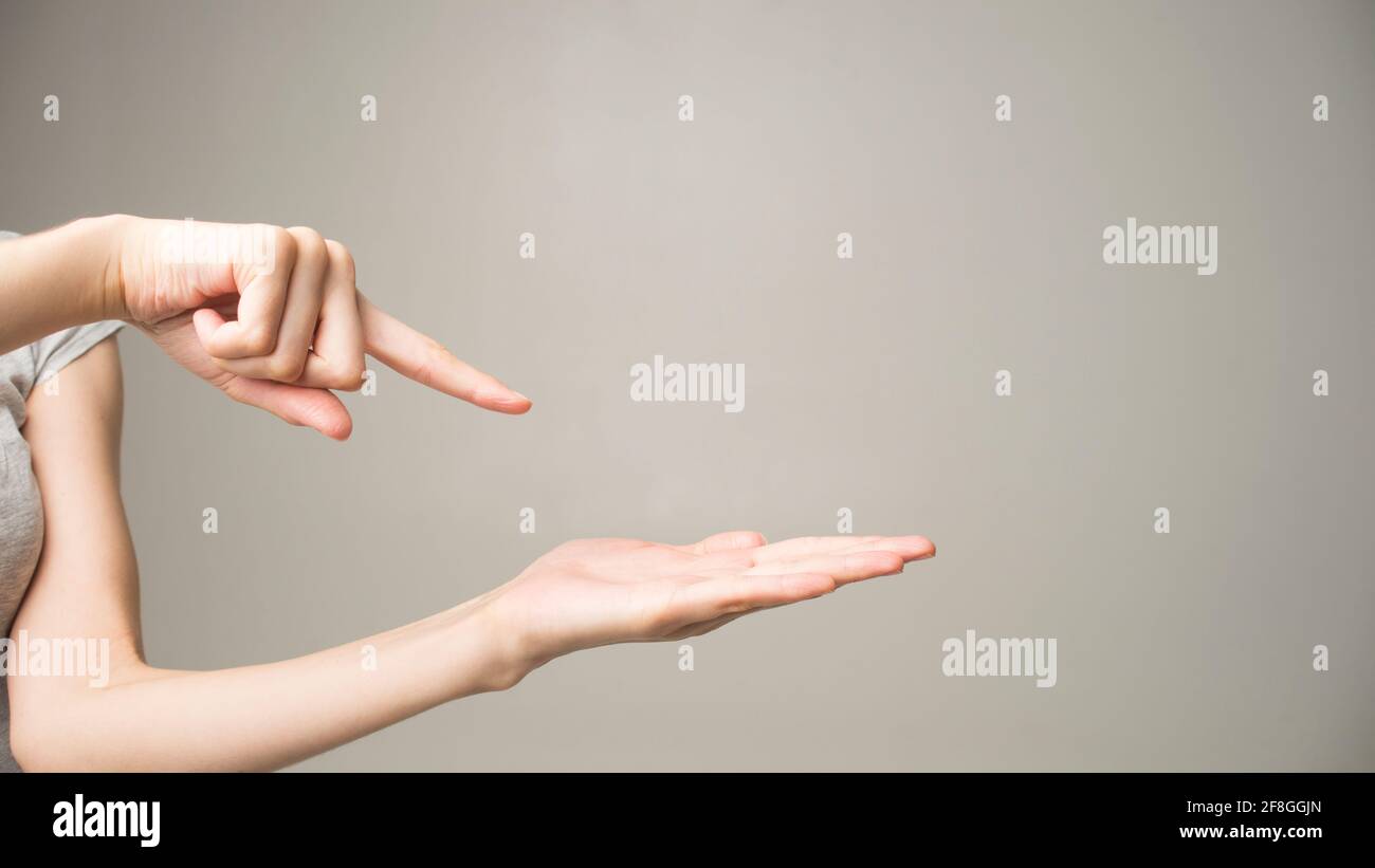 woman points her fingers at something Stock Photo - Alamy