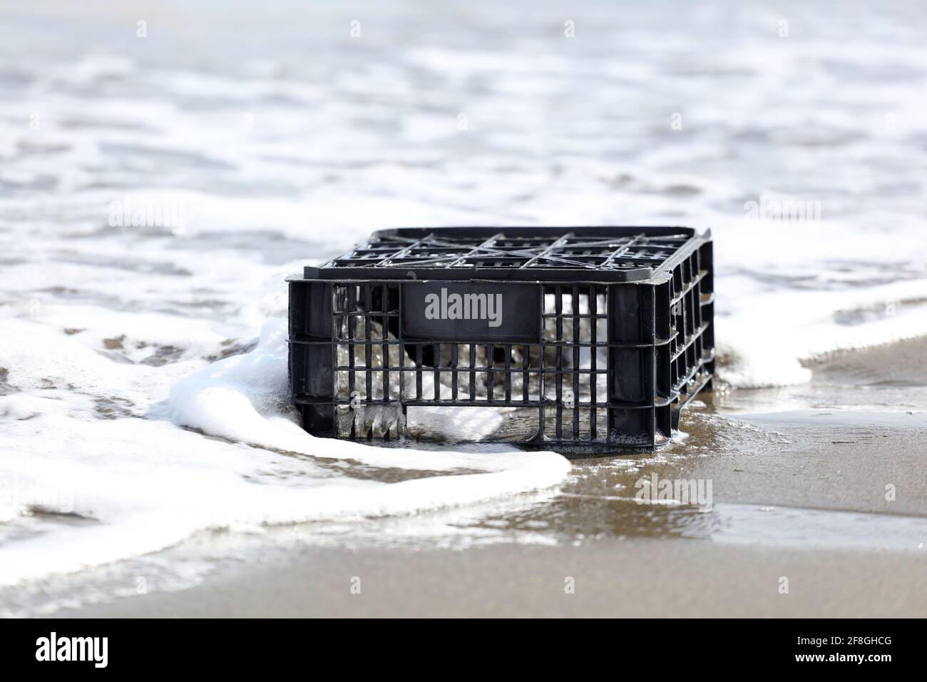 black plastic box thrown on the shore, environmental pollution Stock ...