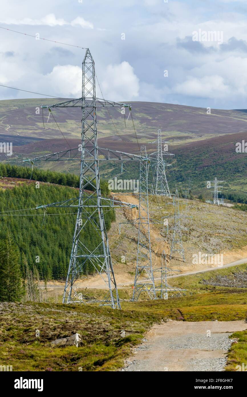 Overhead power distribution pylons carrying high voltage electricity ...