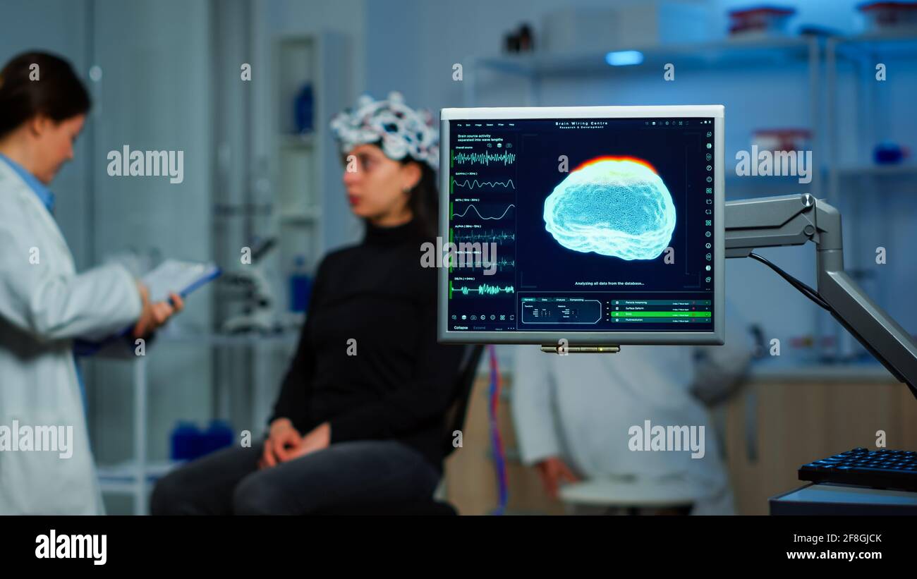 Neurologist doctor analysing nervous system using eeg headset scanning ...