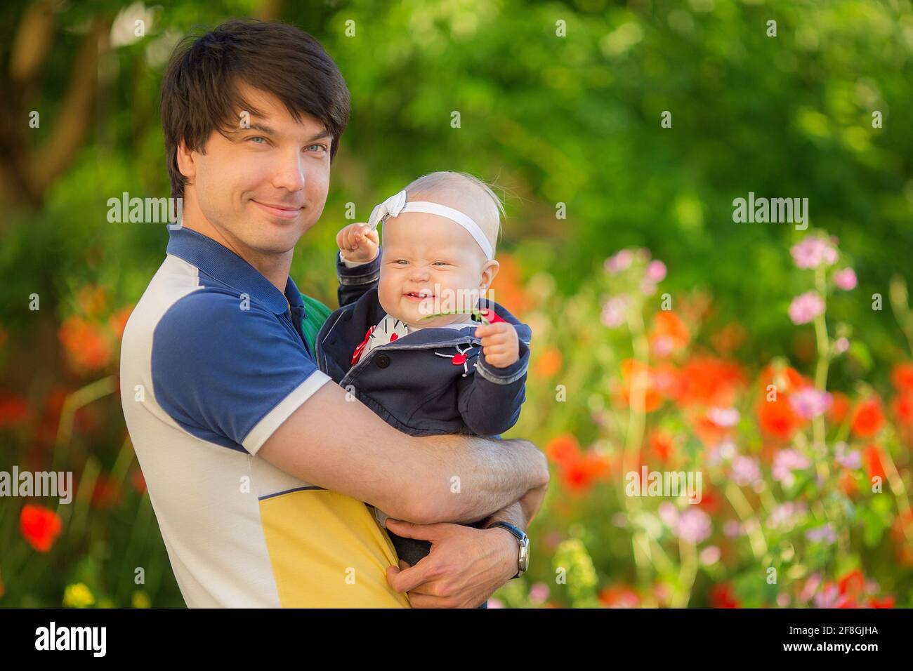 Happy father and child playing together on the poppy meadow Stock Photo ...