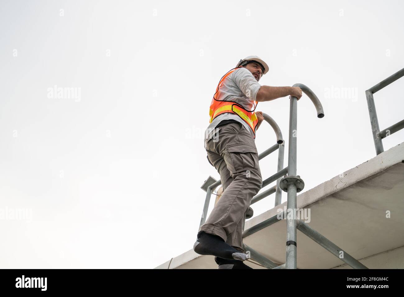 Construction worker climbing ladder hi-res stock photography and images ...