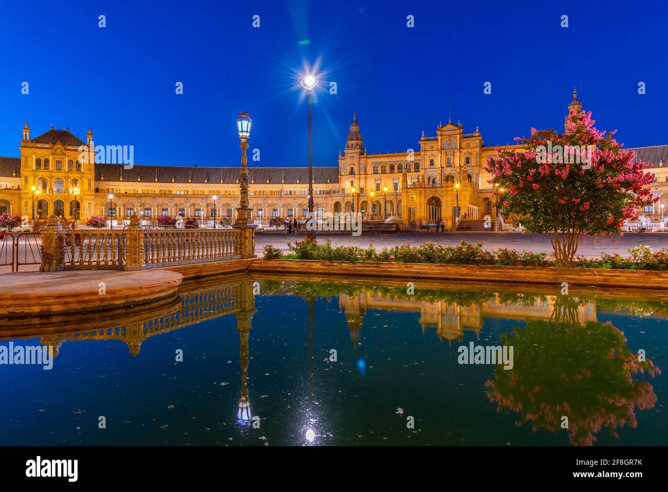 Plaza de Espana reflected on water during night, Sevilla, Spain Stock ...