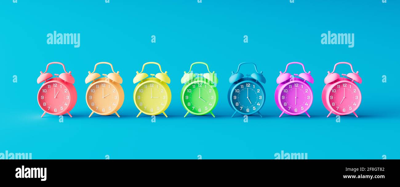 Colorful alarm clocks lined up in row. Creative concept on blue background. 3d render 3d ...