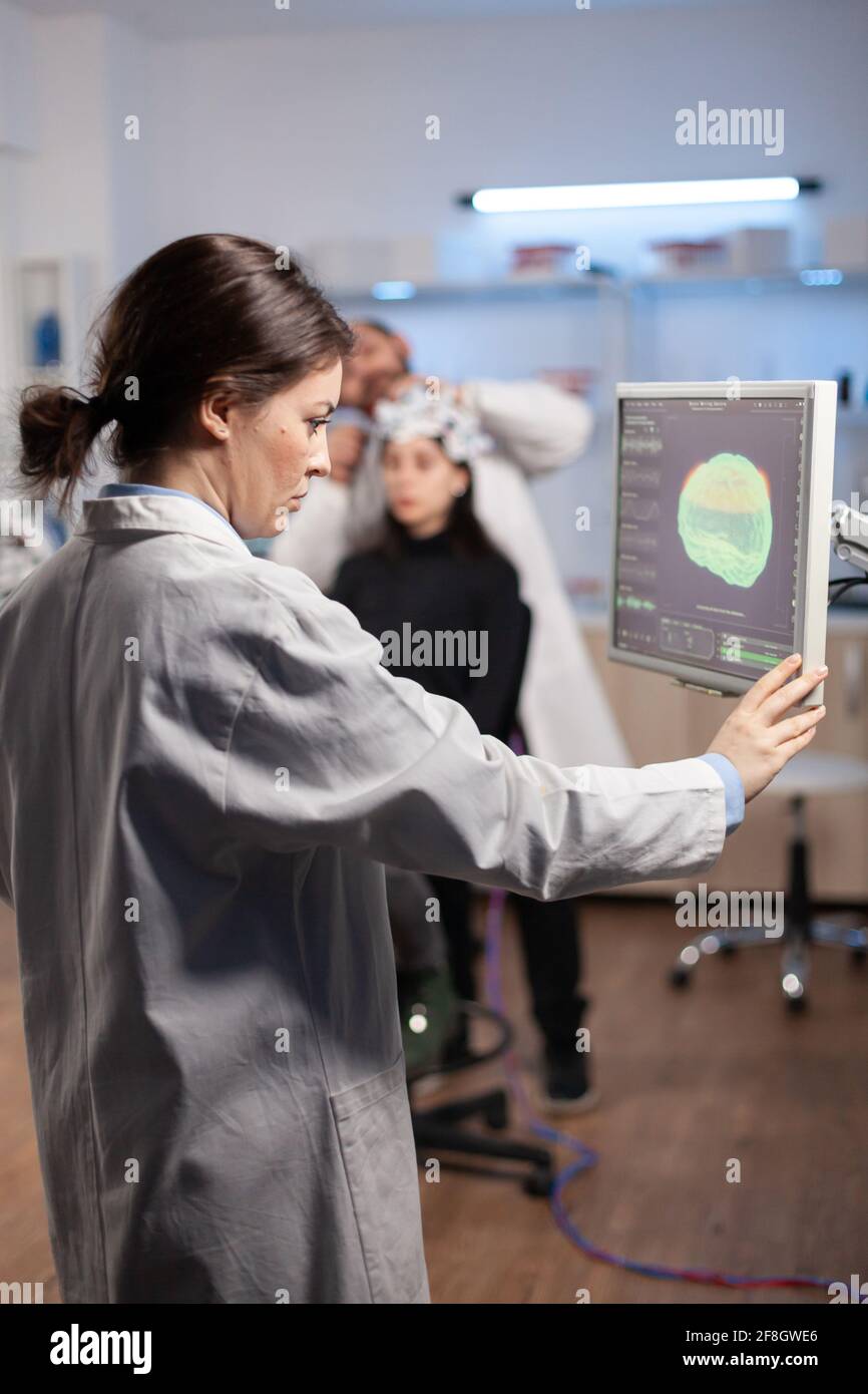 Neurology scientist examining brain nervous system scan on on monitor ...