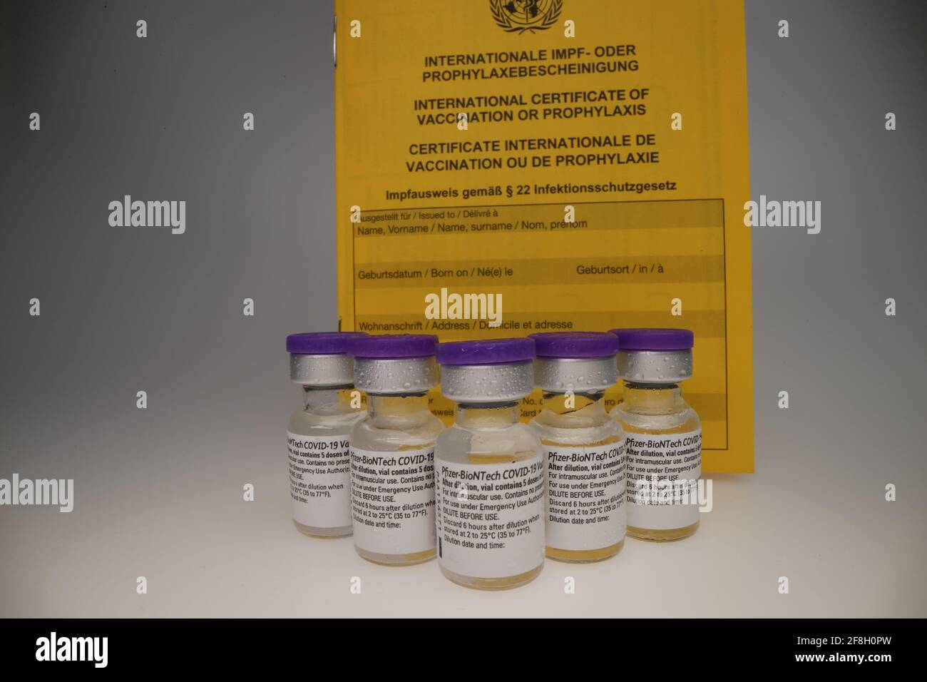 original comirnaty vaccine vial arranged in a group in front of a white ...