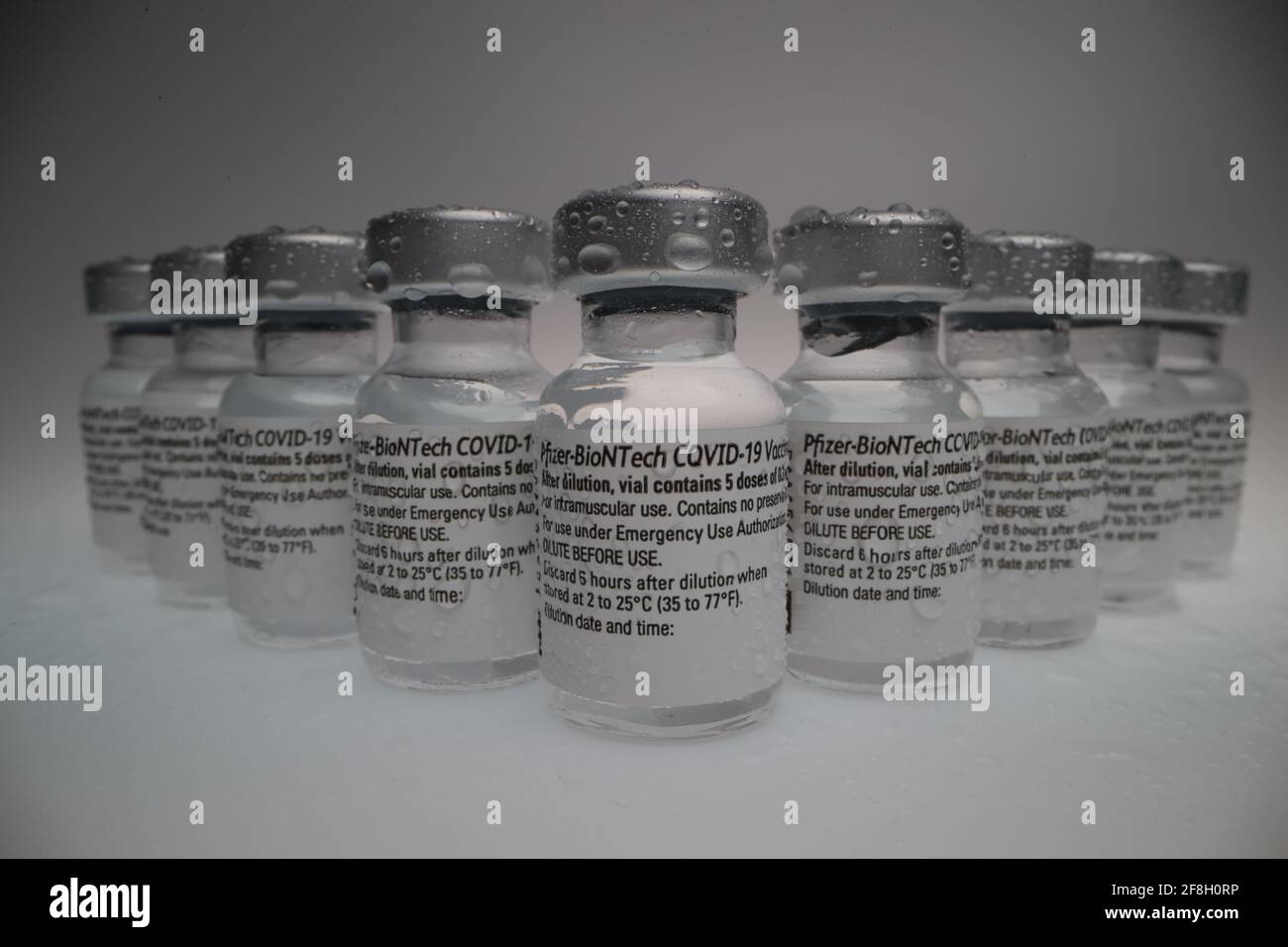 original comirnaty vaccine vial arranged in a group in front of a white ...