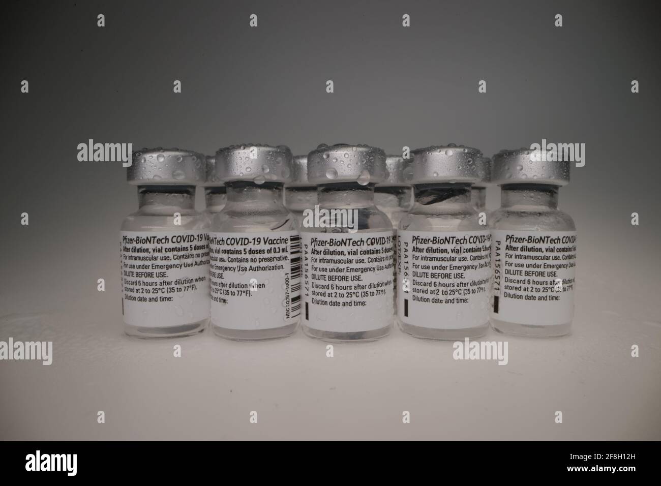 original comirnaty vaccine vial arranged in a group in front of a white ...