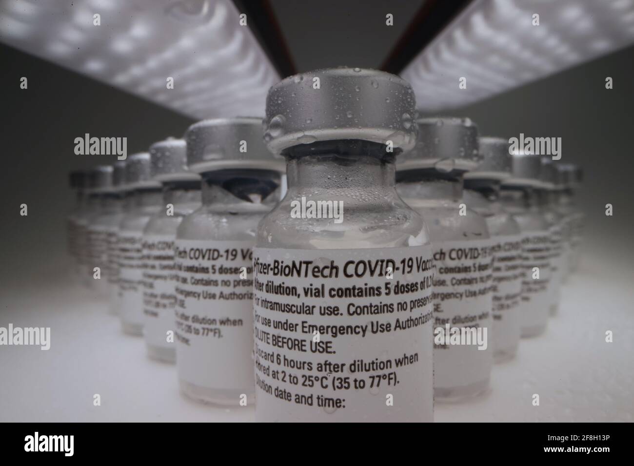 original comirnaty vaccine vial arranged in a group in front of a white ...