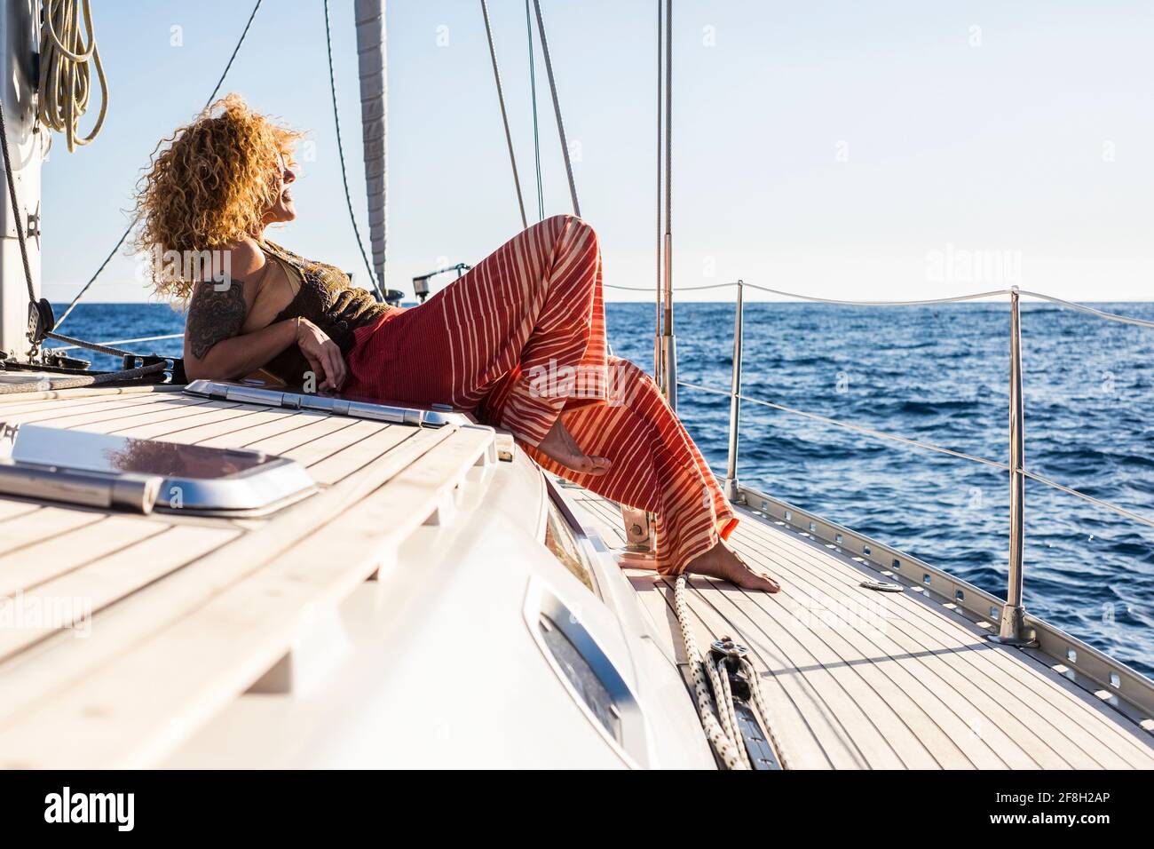 Attractive woman sailing on a yacht on summer day - relax and vacation ...