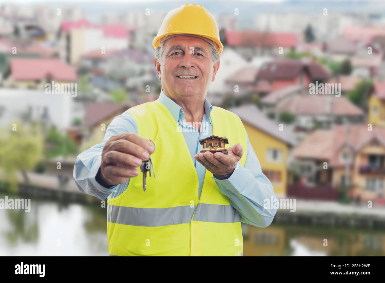 Cheerful old man constructor wearing yellow hardhat equipment showing ...
