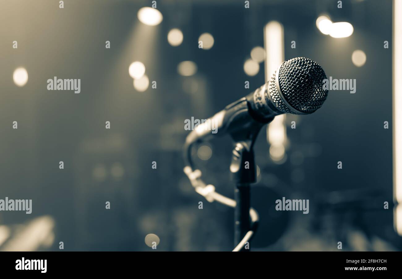 Close up of a microphone on a concert stage with beautiful lighting ...
