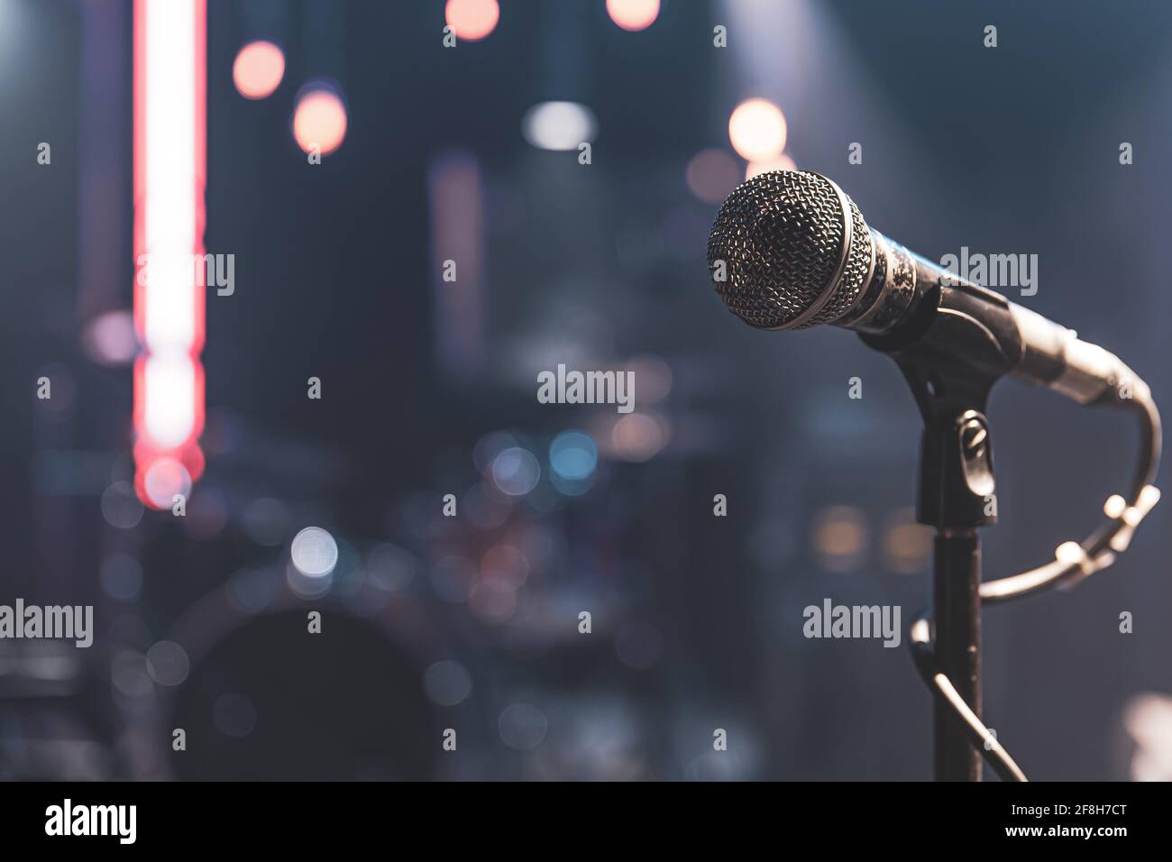 Close up of a microphone on a concert stage with beautiful lighting ...