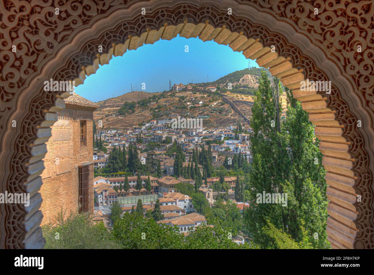 Albaicin district viewed through decorated windows of Nasrid Palace at ...