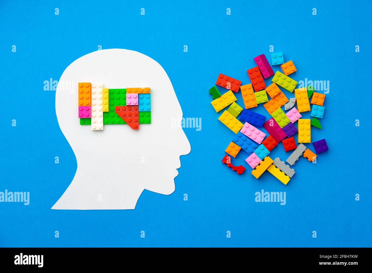 Papercut silhouette of human head with colorful constructor pieces ...