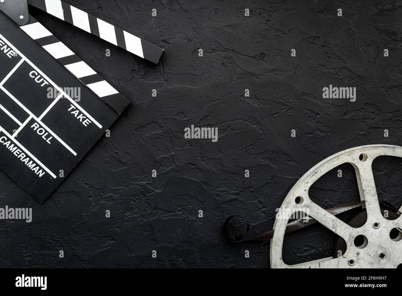 Movie clapper with film reel. Cinema background Stock Photo - Alamy