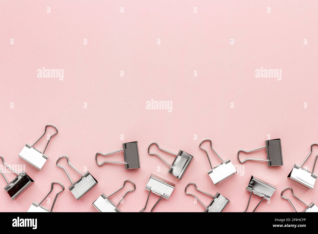 Paper binder clips. Stationery and office supplies background Stock ...