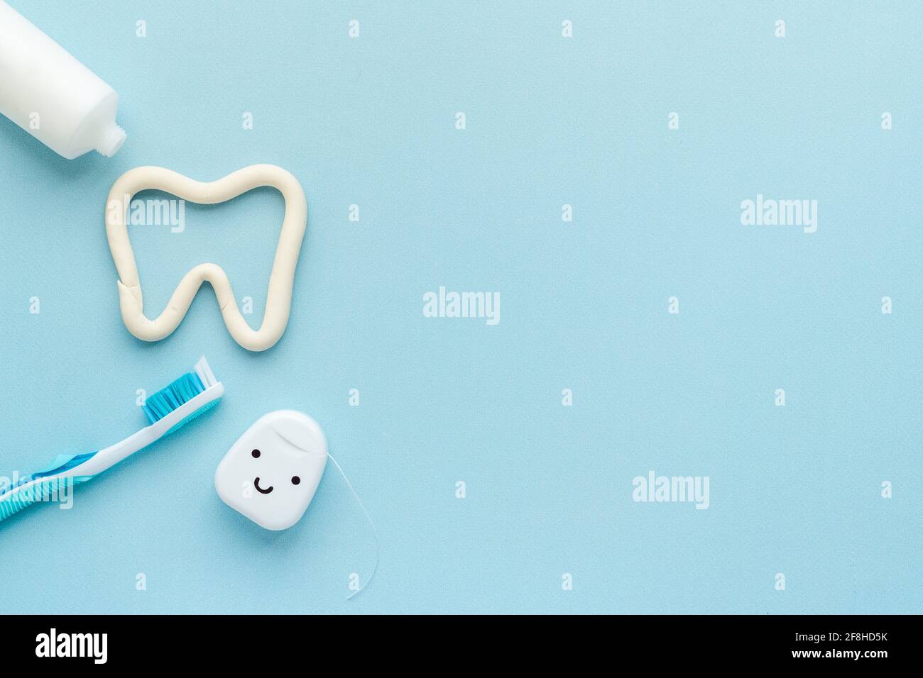 Tooth shape with tube of toothpaste and toothbrush. Dental hygiene ...