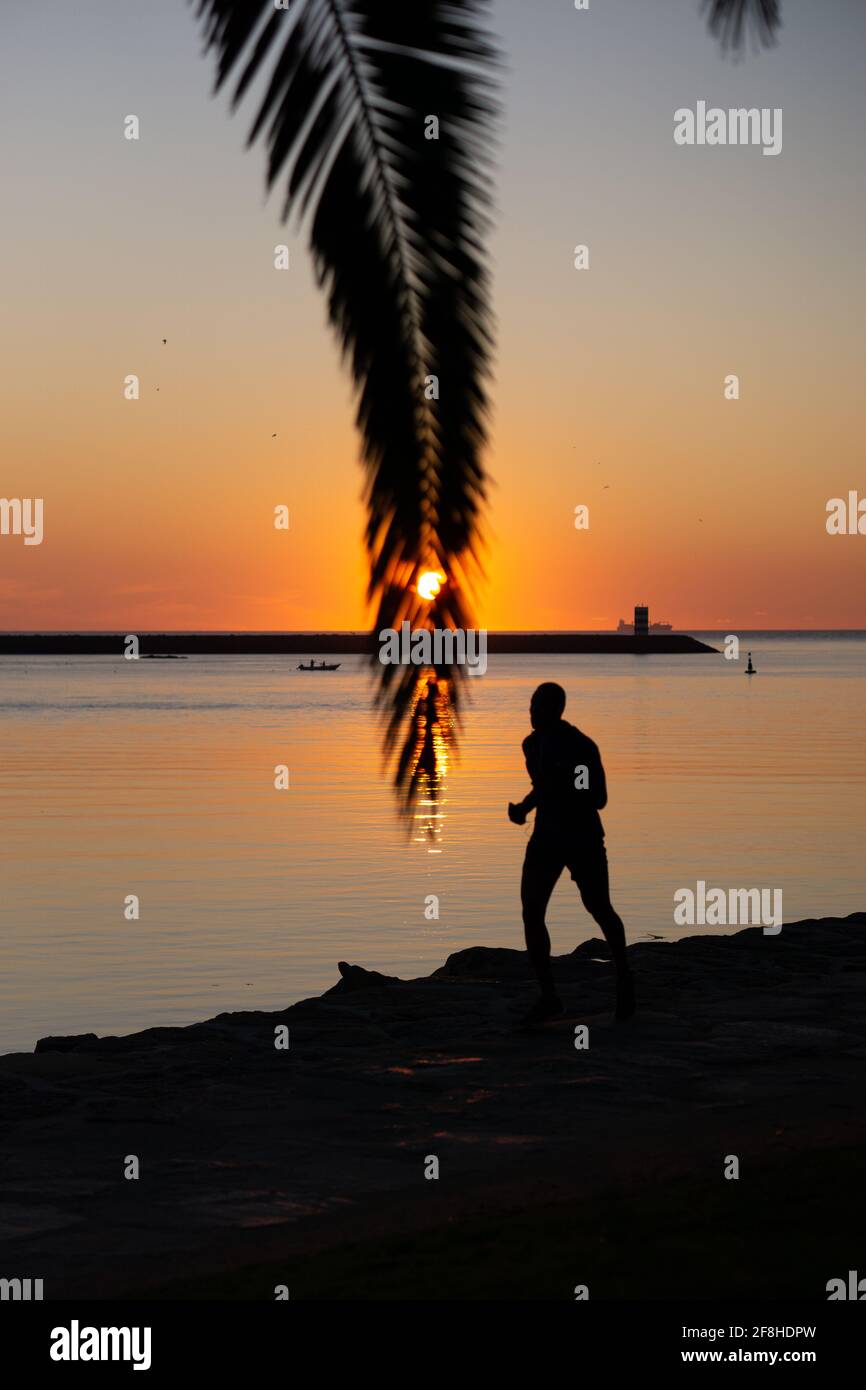 Silhouette man running near sea hi-res stock photography and images - Alamy