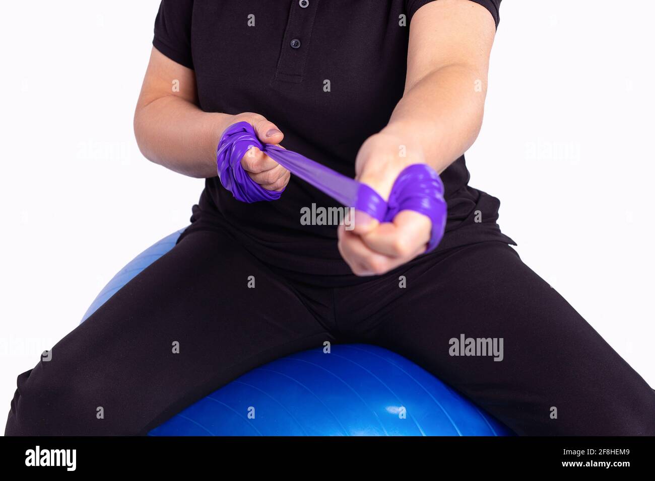 Cropped photo of strong female athlete hands exercises with violet ...