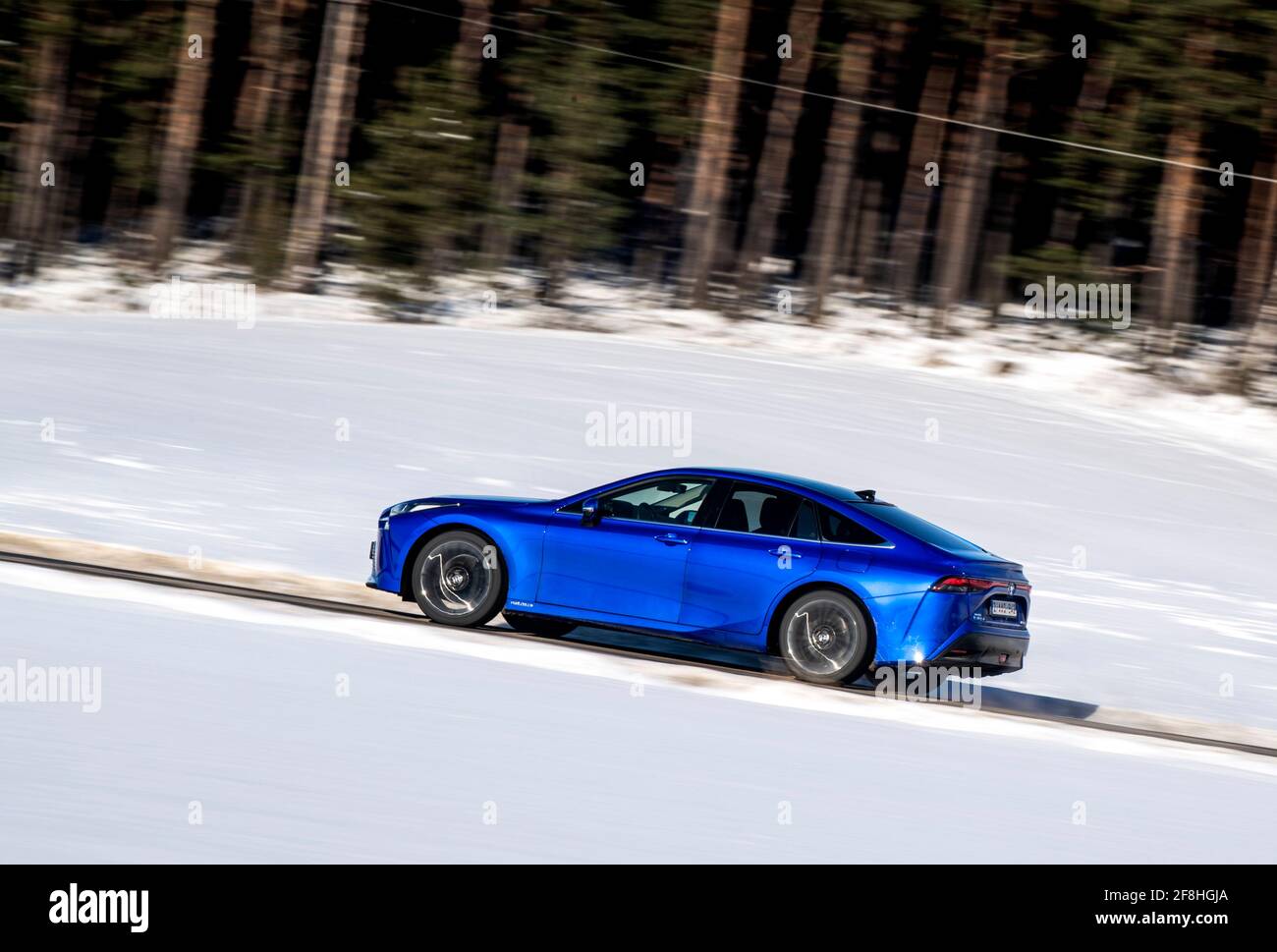Toyota Mirai hydrogen fuel cell vehicle (FCV) . A blue car driving on a ...