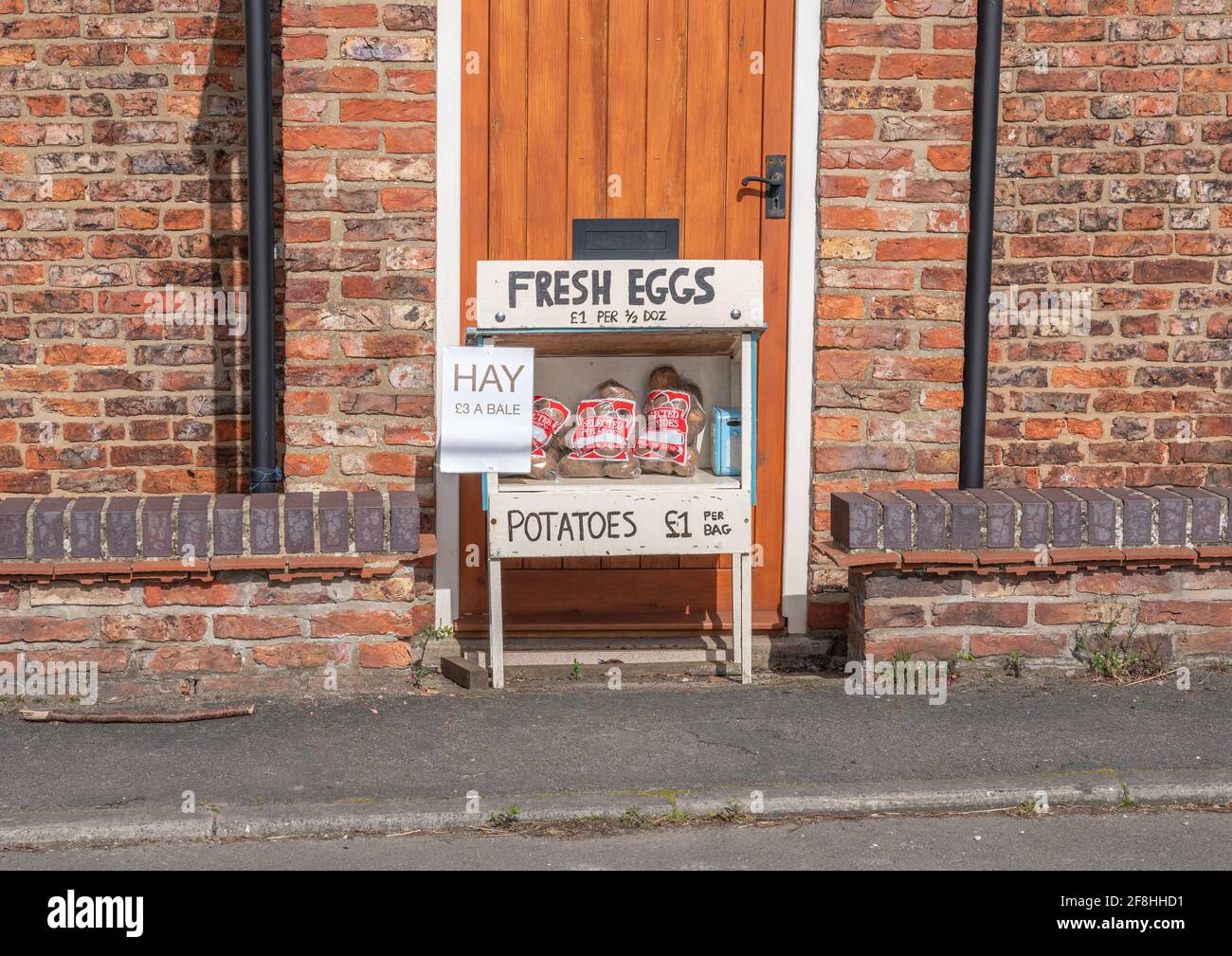 Small roadside produce stall with eggs, hay and potatoes for sale Stock ...