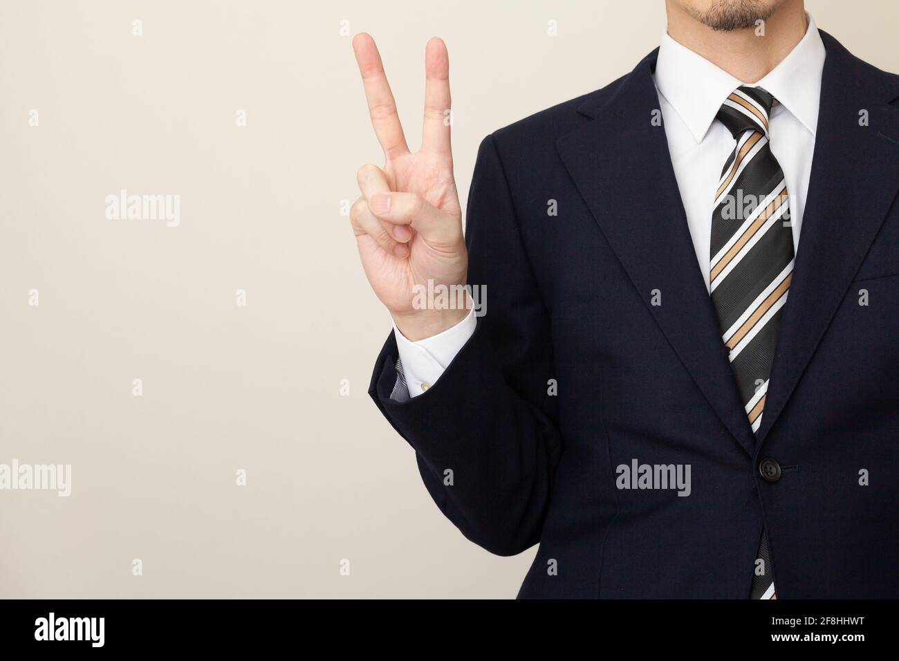 Hands of a man in a suit signing a peace sign Stock Photo - Alamy