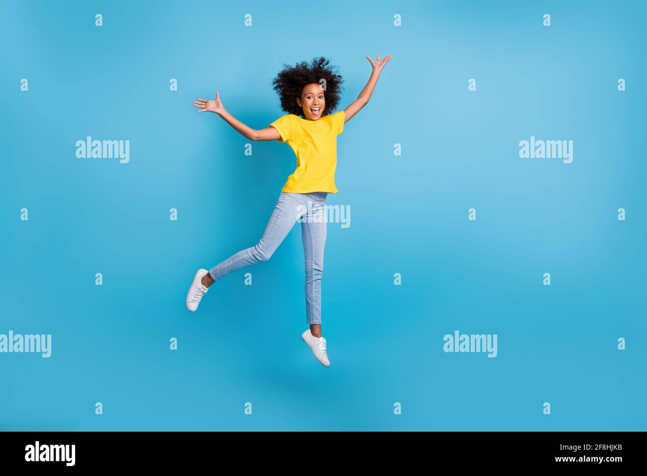 Full length photo of little cute afro american girl jump air raise ...