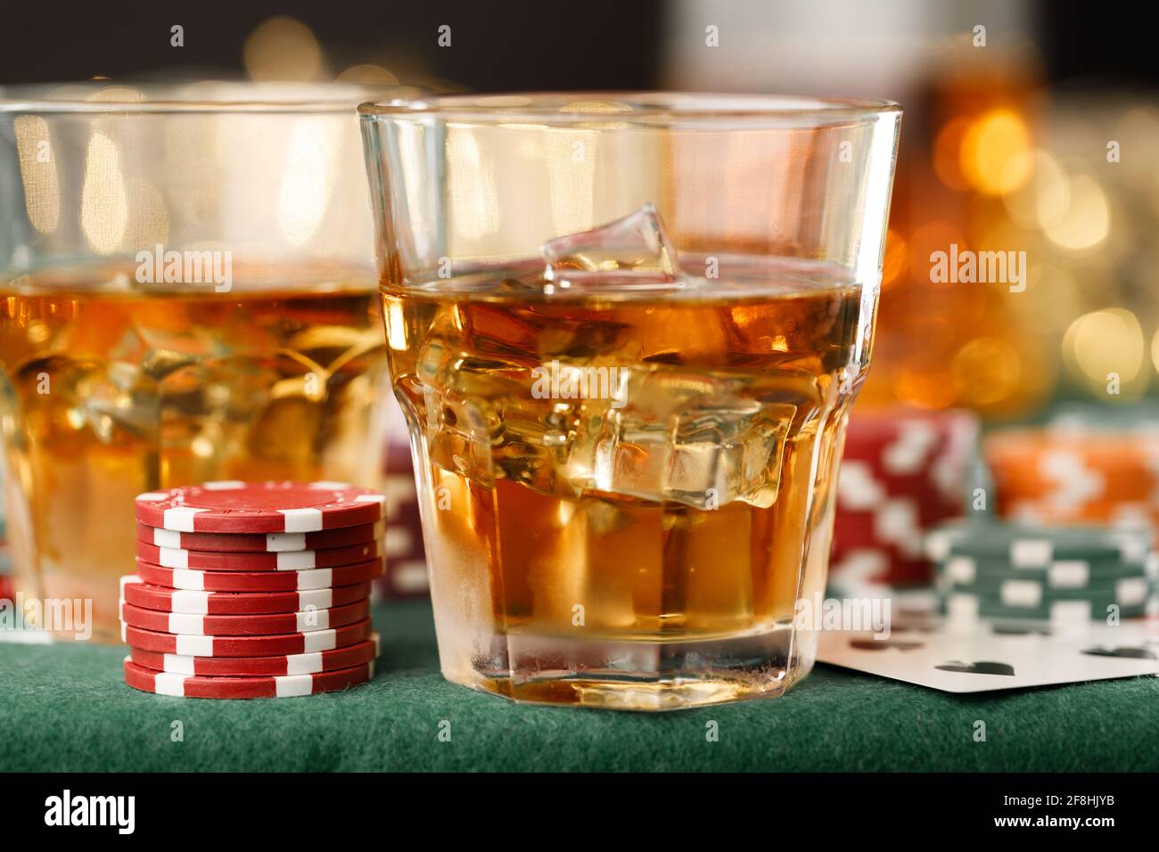 Cards, playing chips and alcohol in glass Stock Photo - Alamy