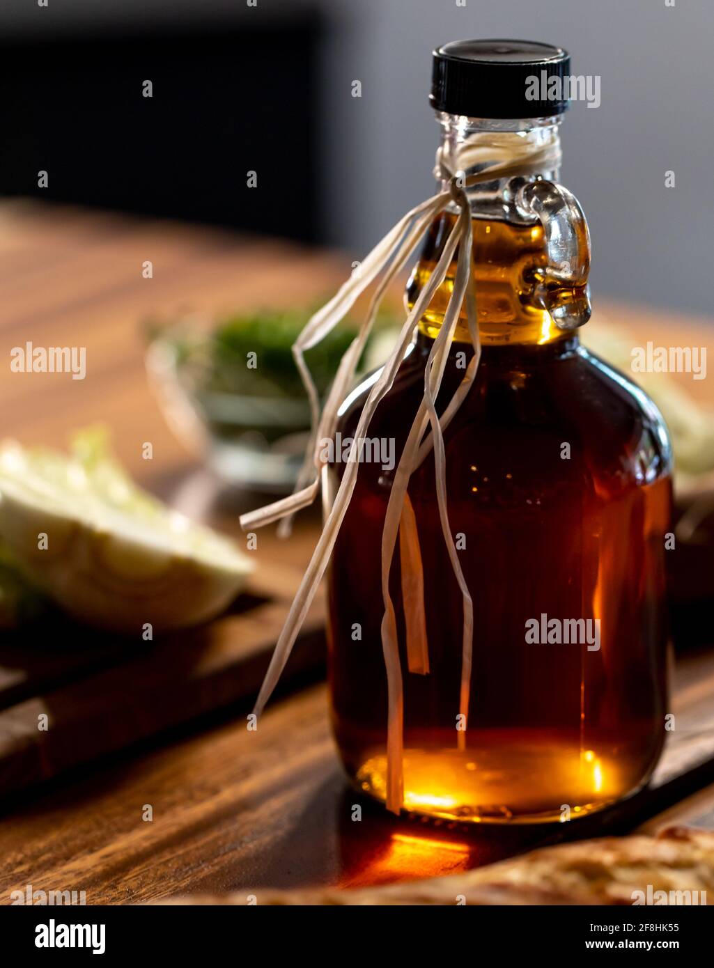 glass bottle of maple syrup with beautiful back light Stock Photo - Alamy