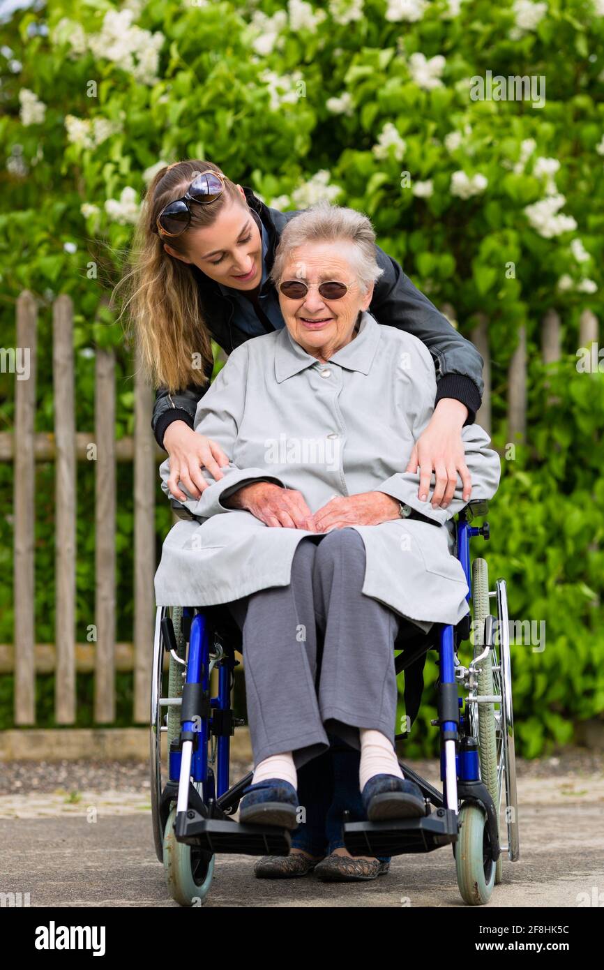 Pushing grandma in wheelchair hi-res stock photography and images - Alamy