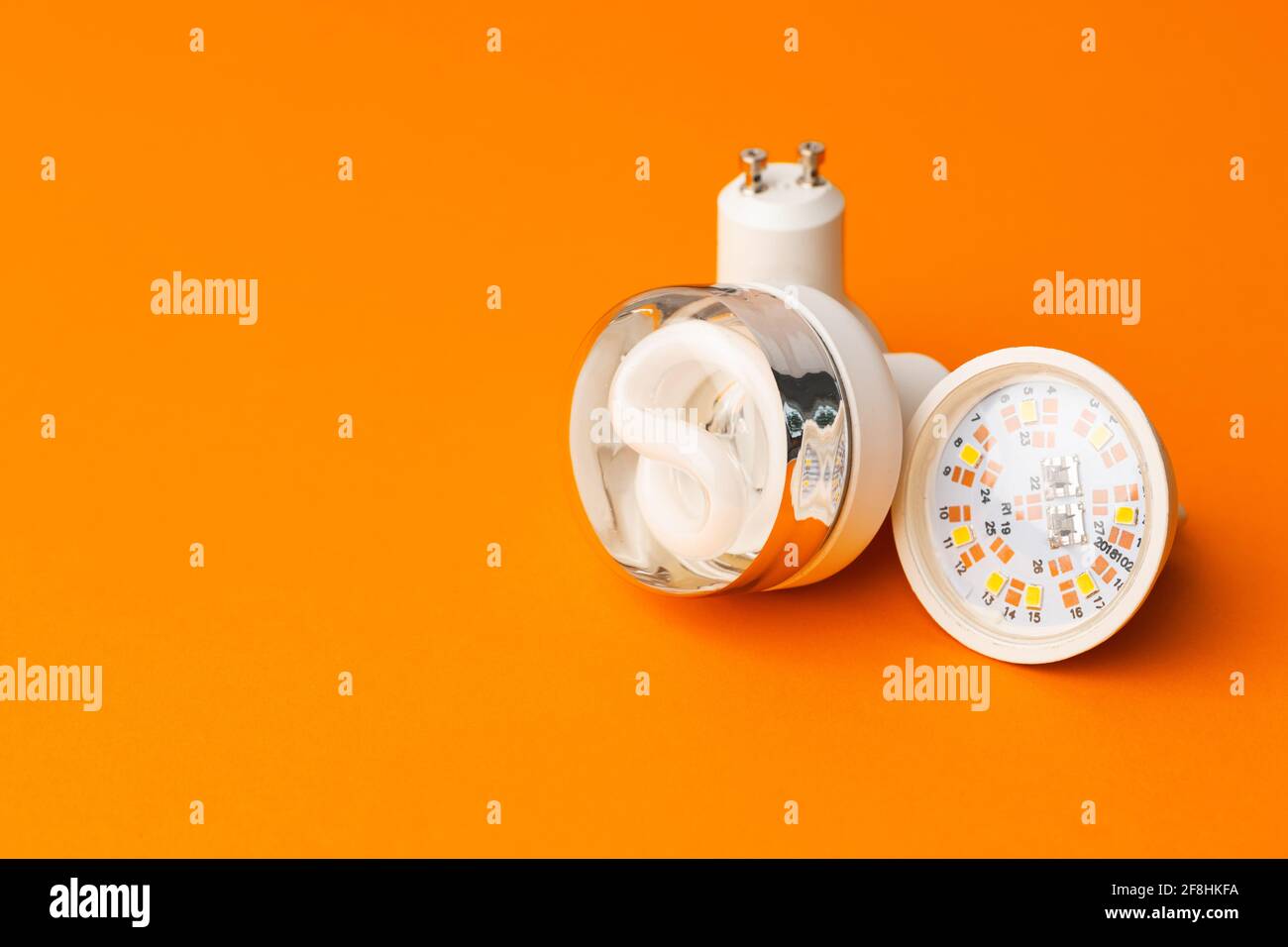 Light bulb on bright orange background top view Stock Photo - Alamy