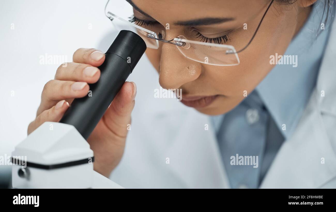 african american scientist in glasses looking through microscope Stock ...